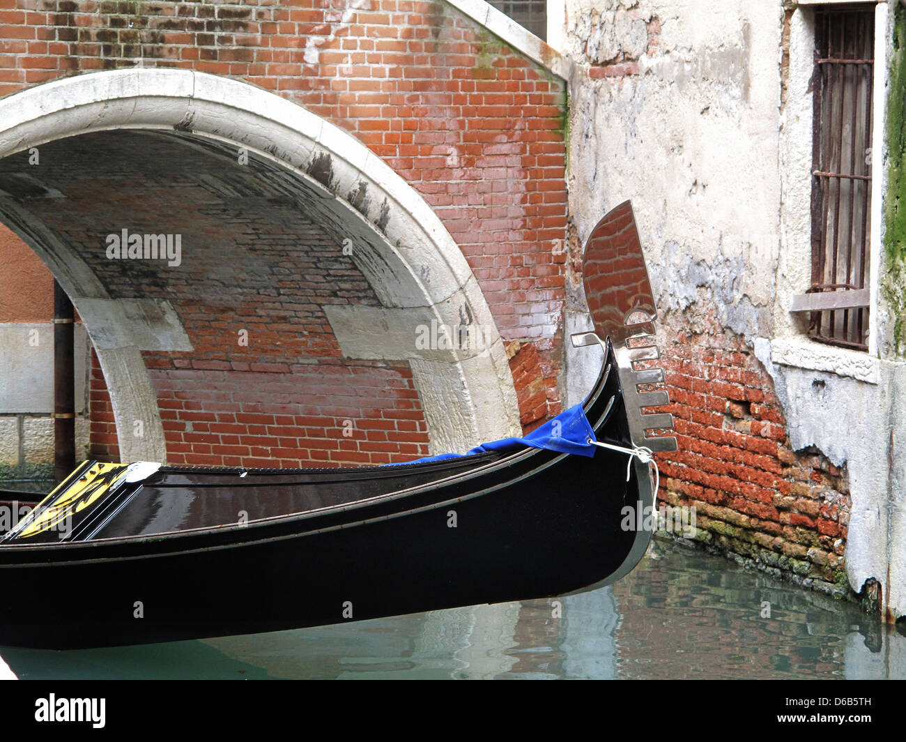 Gondala emerges from under a bridge in Venice Stock Photo - Alamy