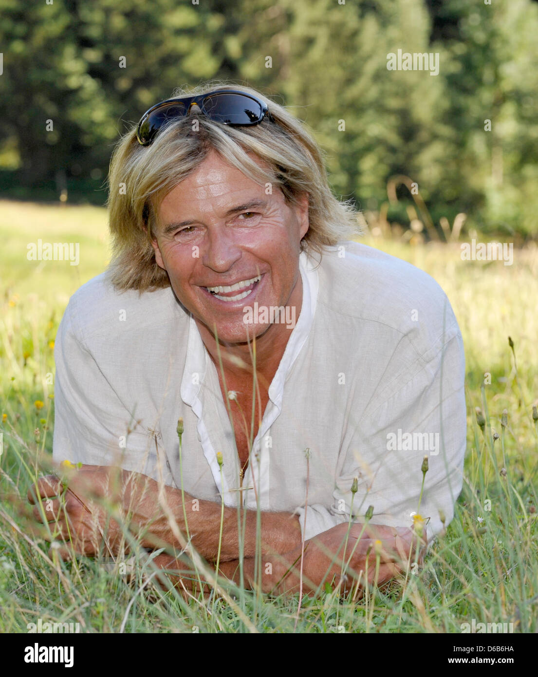 Hansi Hinterseer lies on a meadow during the presentation of his new ...