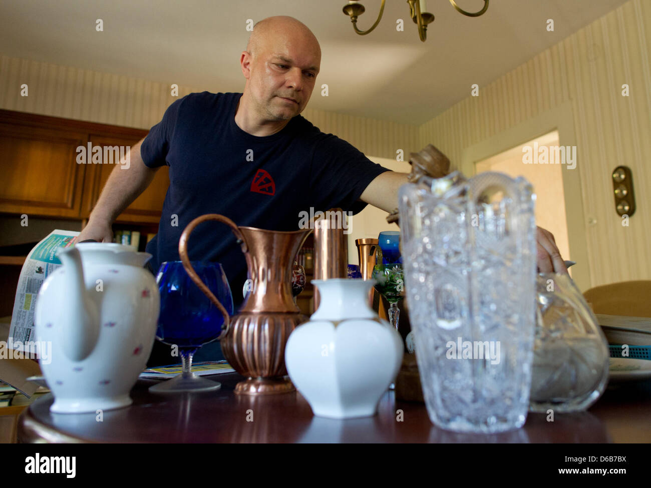 An employee from a house clearing company packs items into boxes in a ...