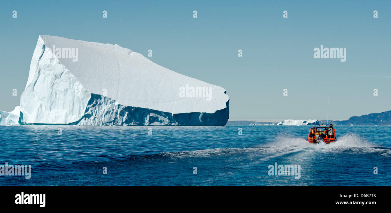 A giant iceberg floats in the Ammassalik District near the village of ...