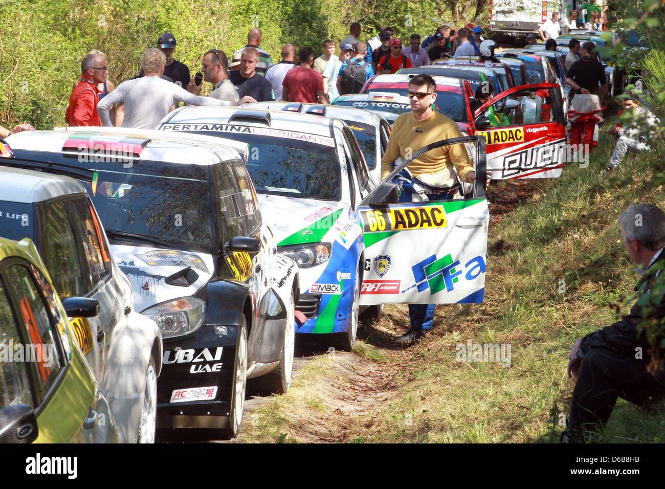 Numerous rally cars stand on the racecourse during the Rallye ...