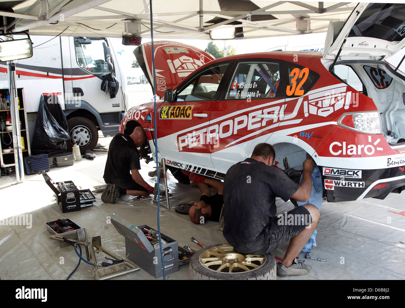 Mechanics work on the Subaru Impreza WRX of Peruvian rally driver ...