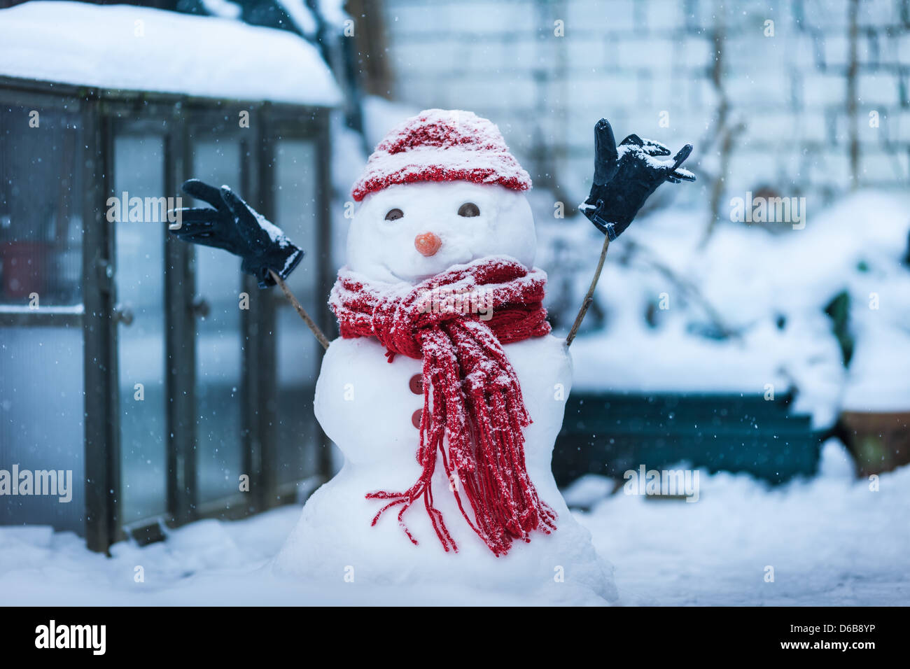 Snowman built on city street Stock Photo - Alamy