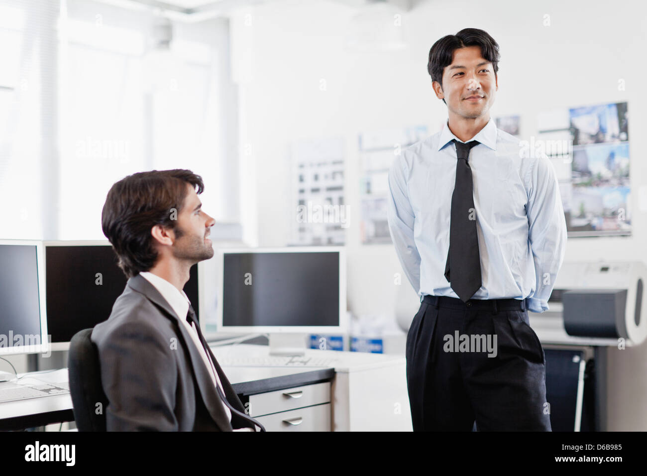 Businessmen talking in office Stock Photo - Alamy