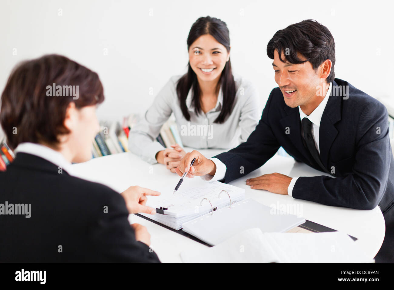 Business people talking at desk Stock Photo - Alamy