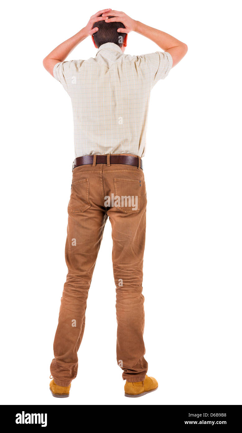 Back view of angry young man in jeans and shirt. Rear view. isolated ...