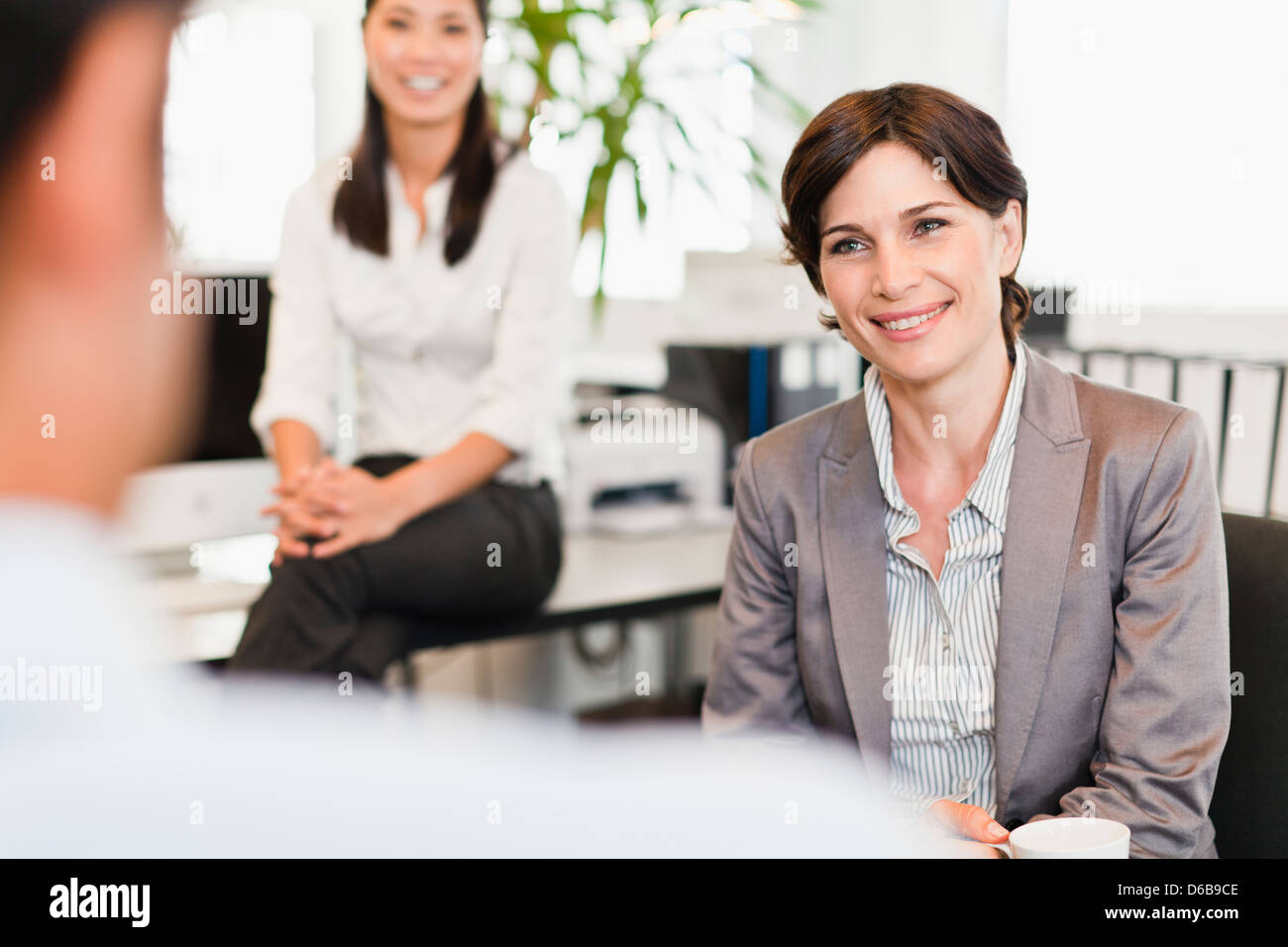 Business people talking in office Stock Photo - Alamy