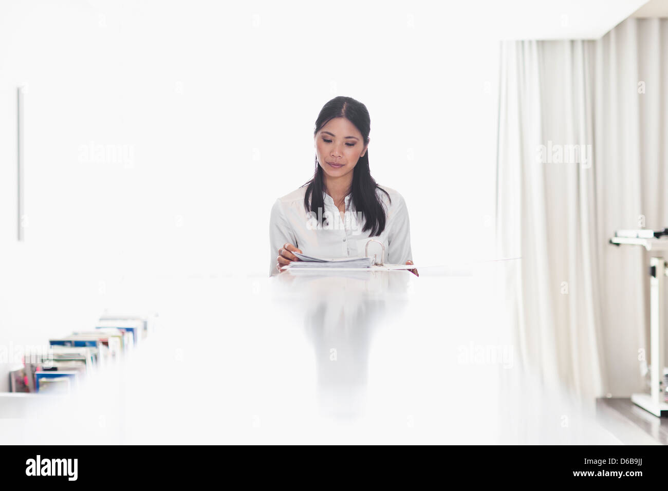 Businesswoman reading at desk Stock Photo - Alamy
