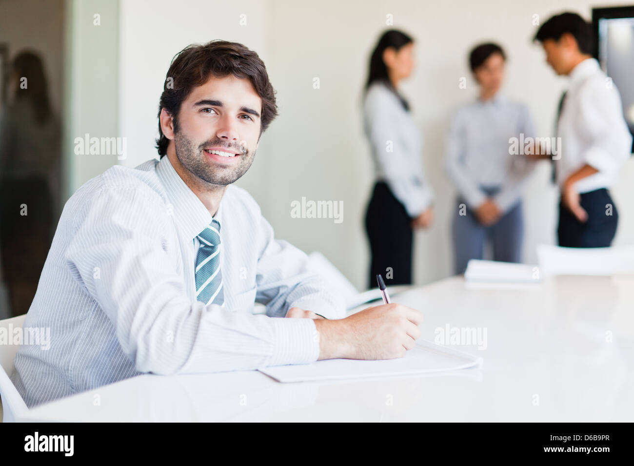 Businessman taking notes in meeting Stock Photo - Alamy