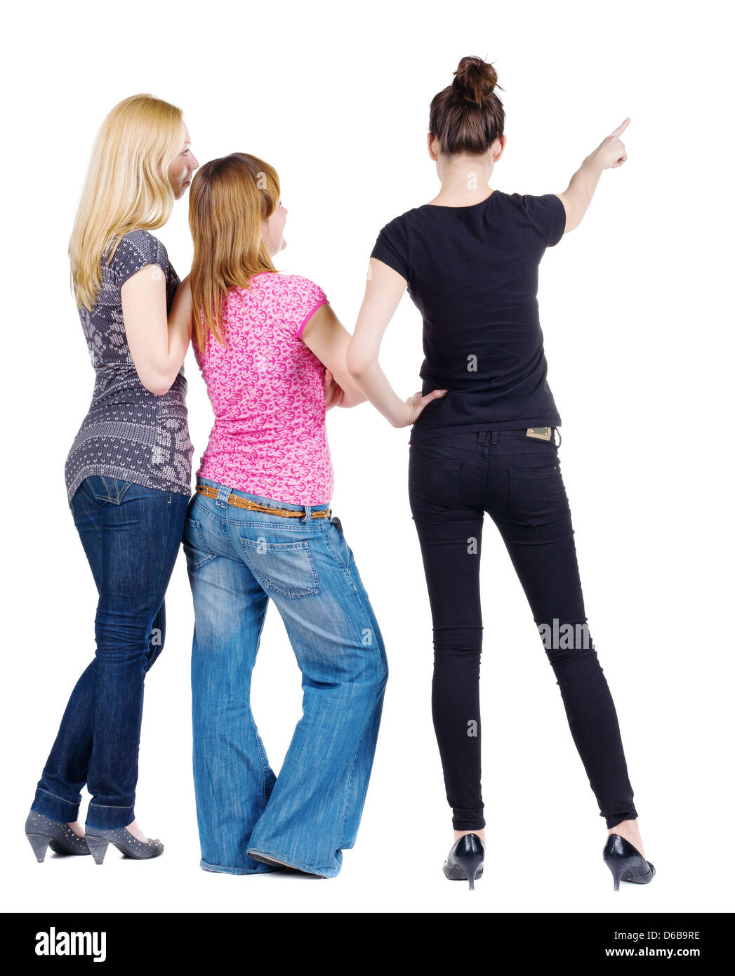 Back view of group beautiful women pointing at wall. Girl friends looks ...