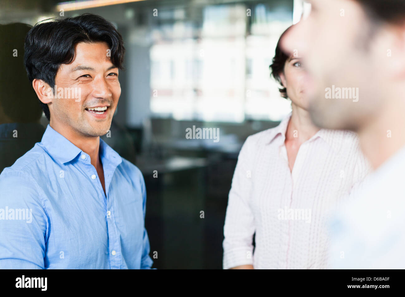 Businessmen smiling at each other Stock Photo - Alamy