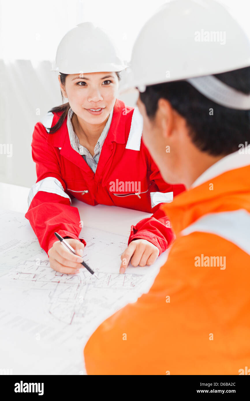 Business people reading blueprints hi-res stock photography and images ...