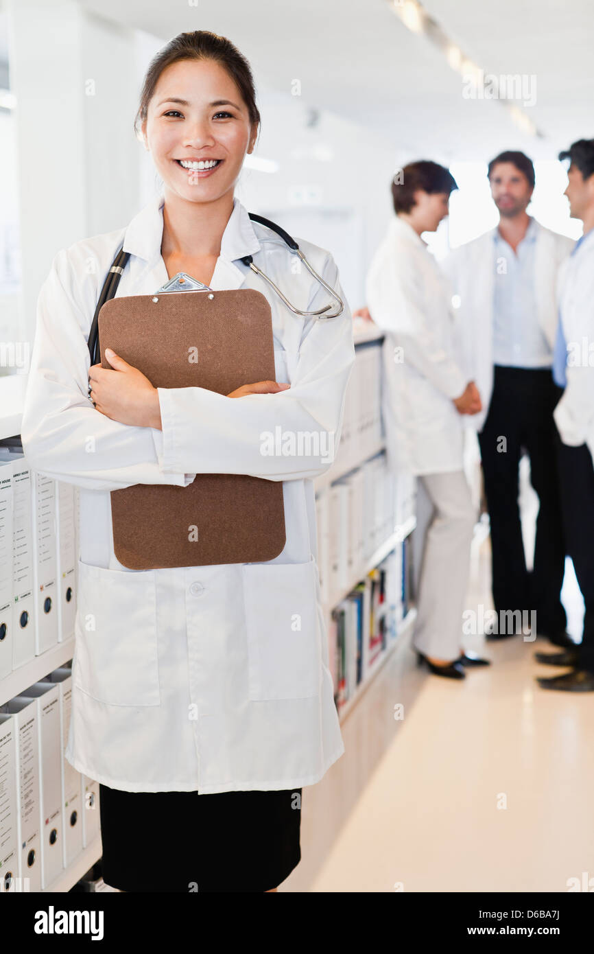 Doctor smiling holding clipboard hi-res stock photography and images ...