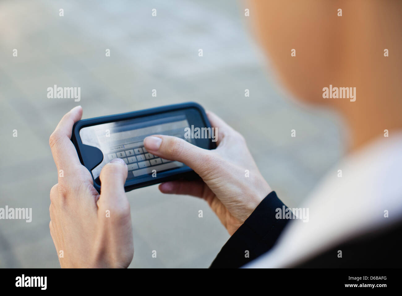 Businesswoman using cell phone outdoors Stock Photo - Alamy