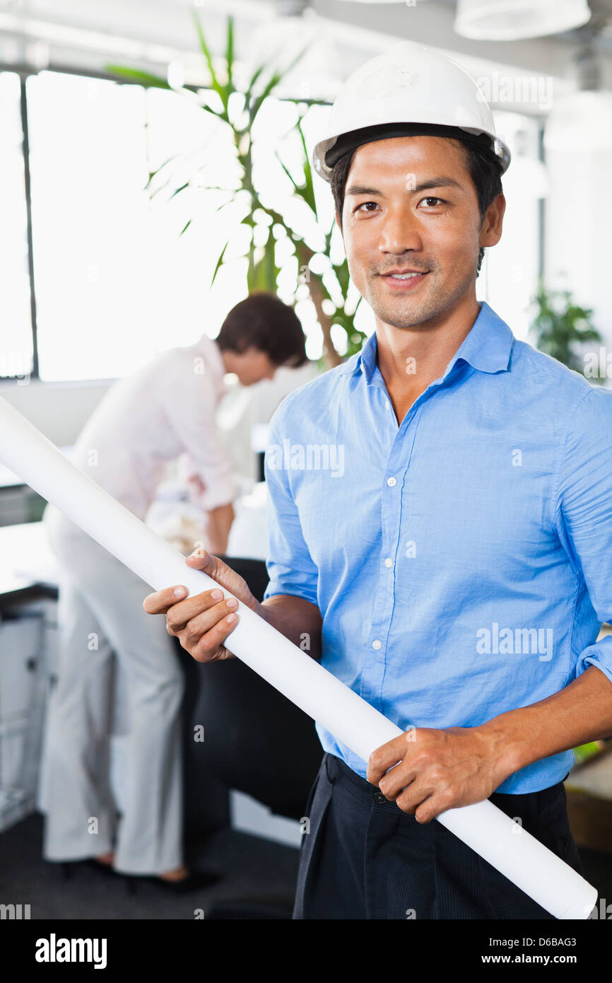 Man holding rolled blueprints hi-res stock photography and images - Alamy