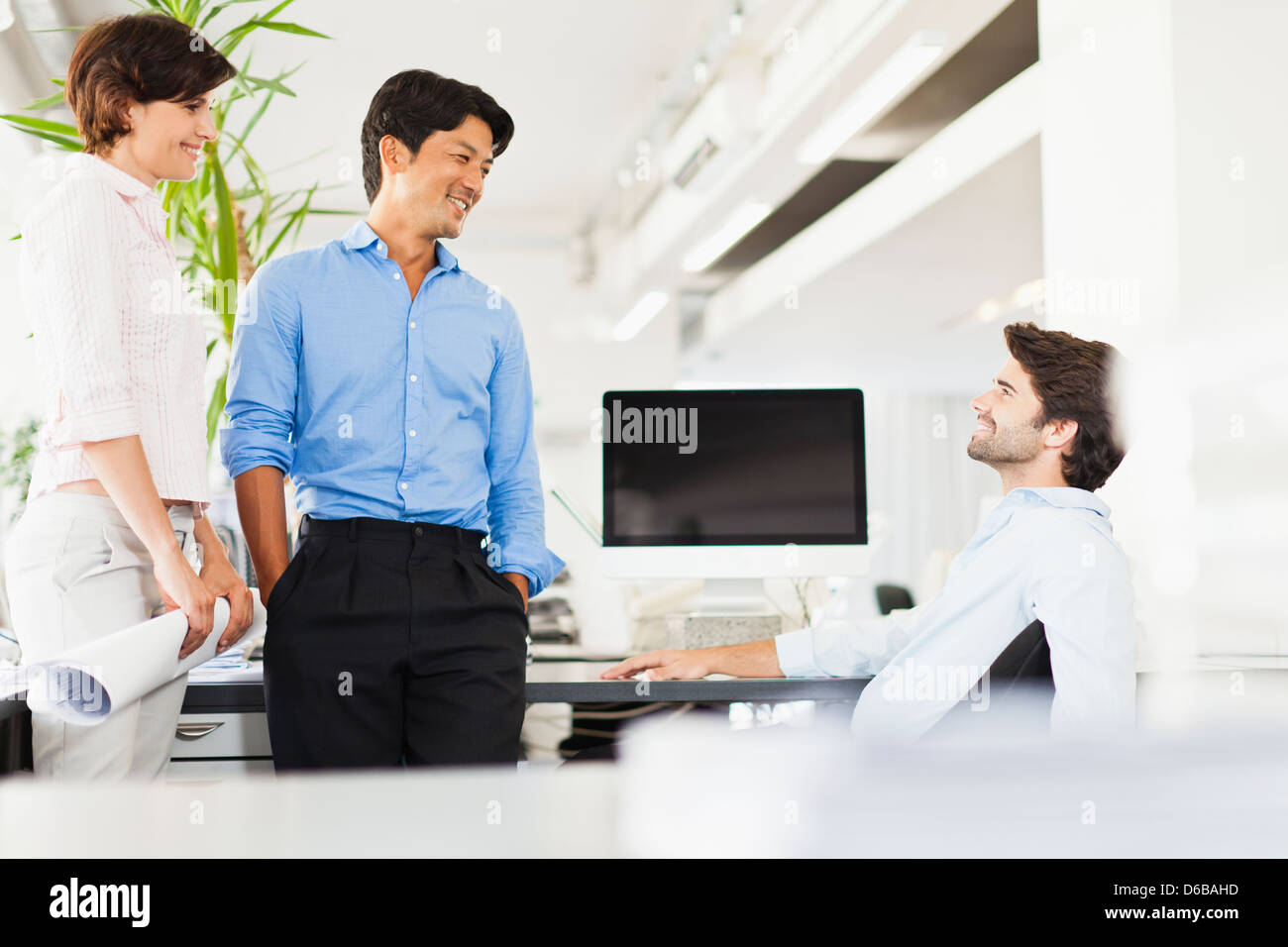 Business people talking at desk Stock Photo - Alamy