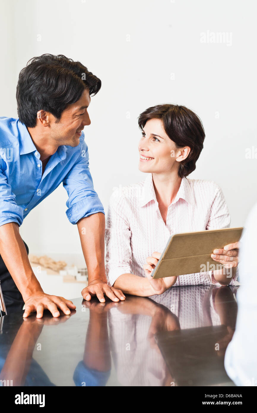 Business people talking at desk Stock Photo - Alamy