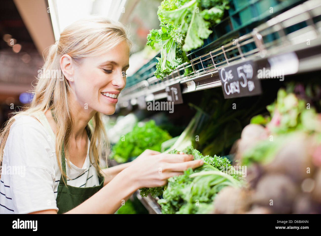 Grocer working in produce section Stock Photo - Alamy