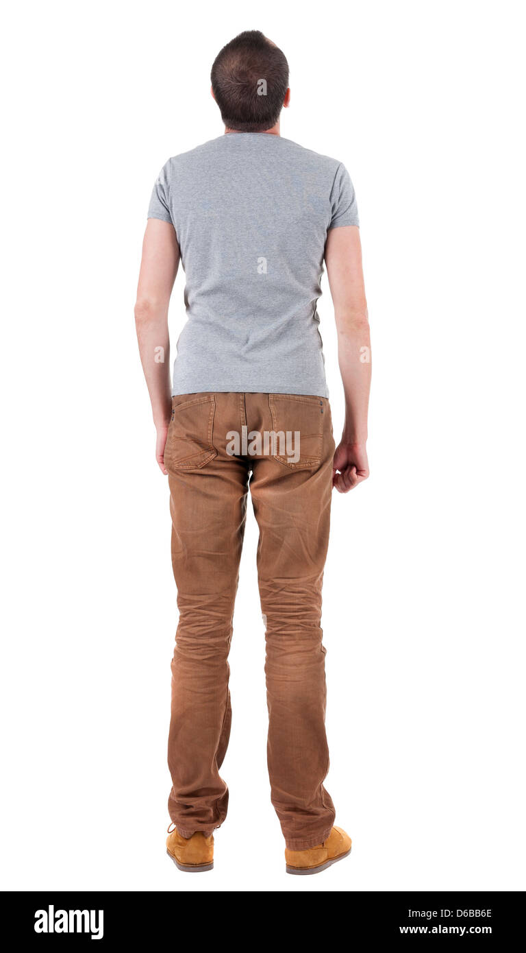 Back view of handsome man in shirt and jeans looking up. Standing young ...