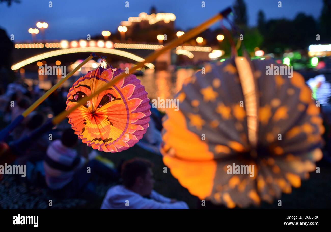 Visitors of a lantern festival enjoy their illuminated city with their ...