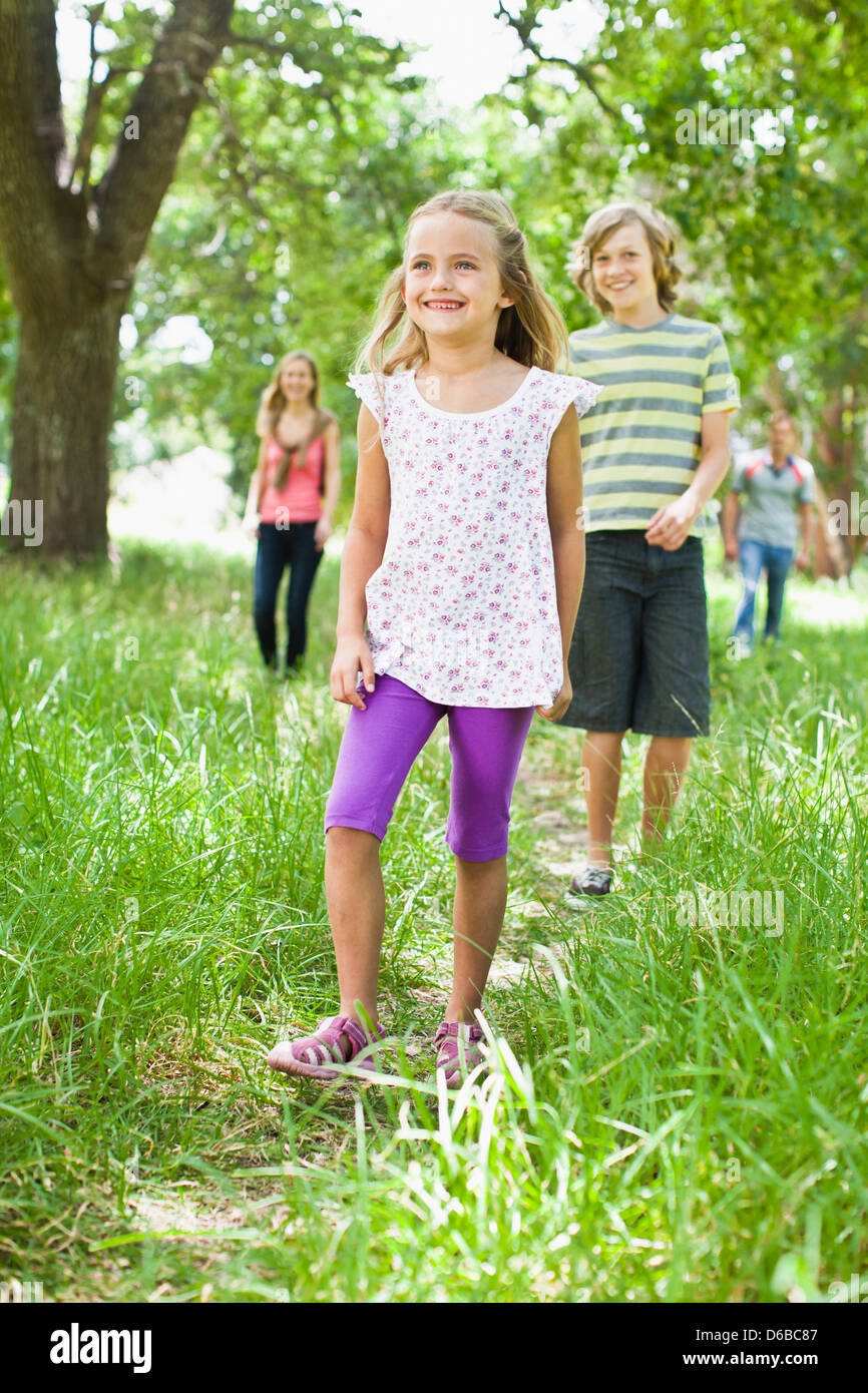 Children walking together in grass Stock Photo - Alamy