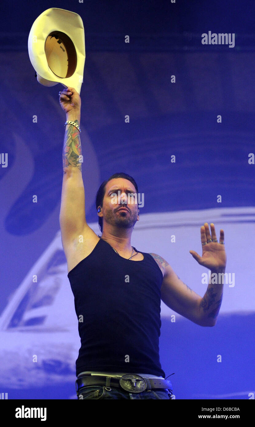 Singer Alec Voelkel of the German band The BossHoss performs on stage ...
