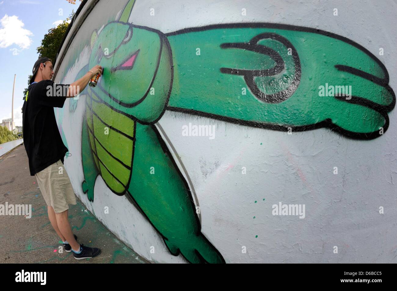 Artist 'Jonas' from Germany sprays a graffiti on one of Germany's ...