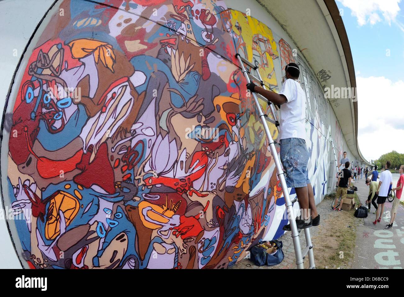 Artists spray graffitis on one of Germany's largest legal graffiti wall ...