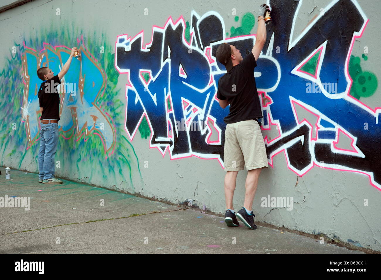 Artists spray graffitis on one of Germany's largest legal graffiti wall ...