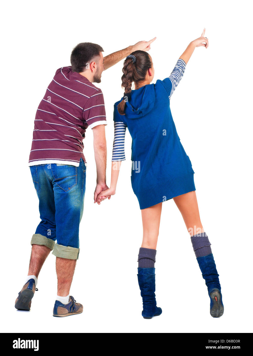 Back view of young couple pointing at white wall. Young pair ...