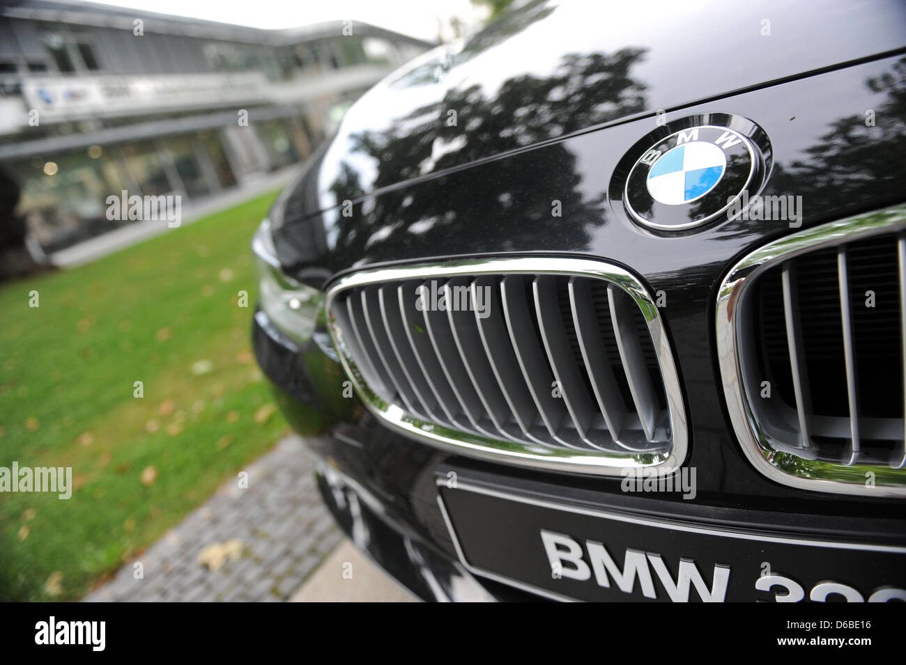A BMW sits in front of a BMW dealership on the Frankfurter Ring in ...