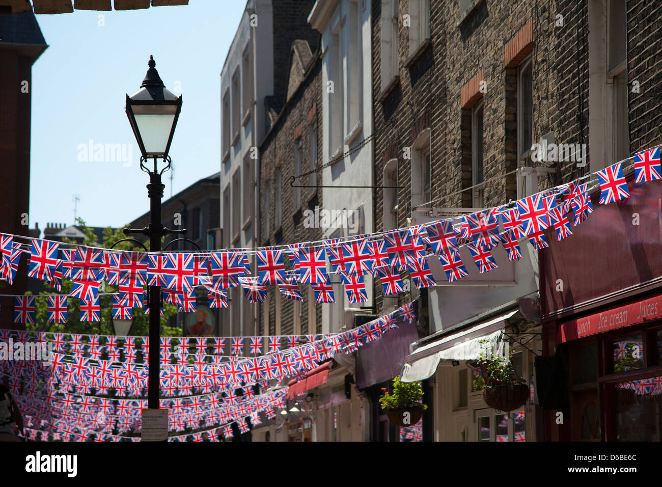 Flags hanging from city buildings Stock Photo - Alamy