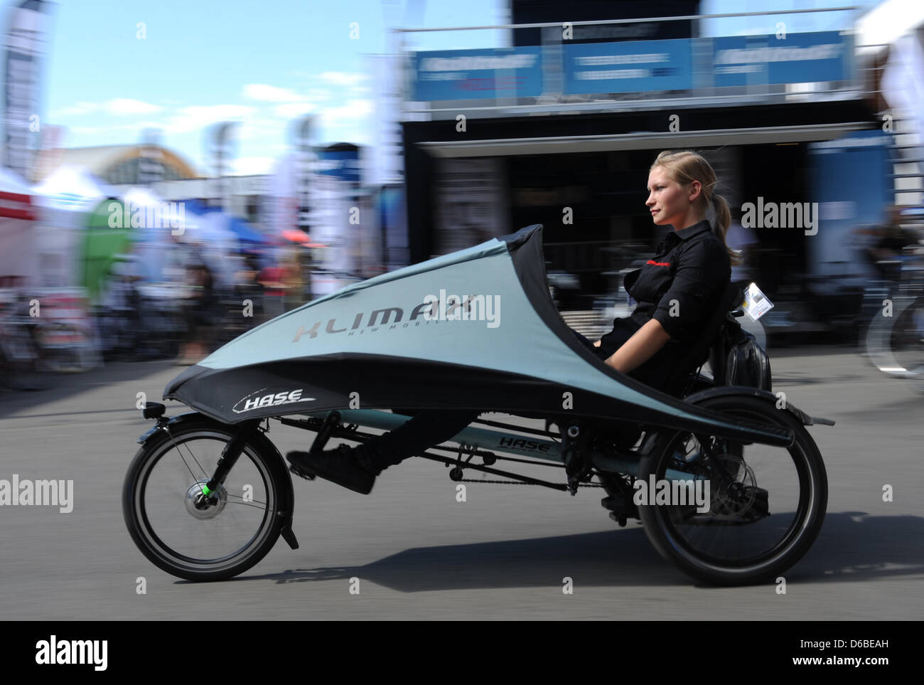 A woman rides an electric recumbent bicycle at the trade fair Eurobike ...