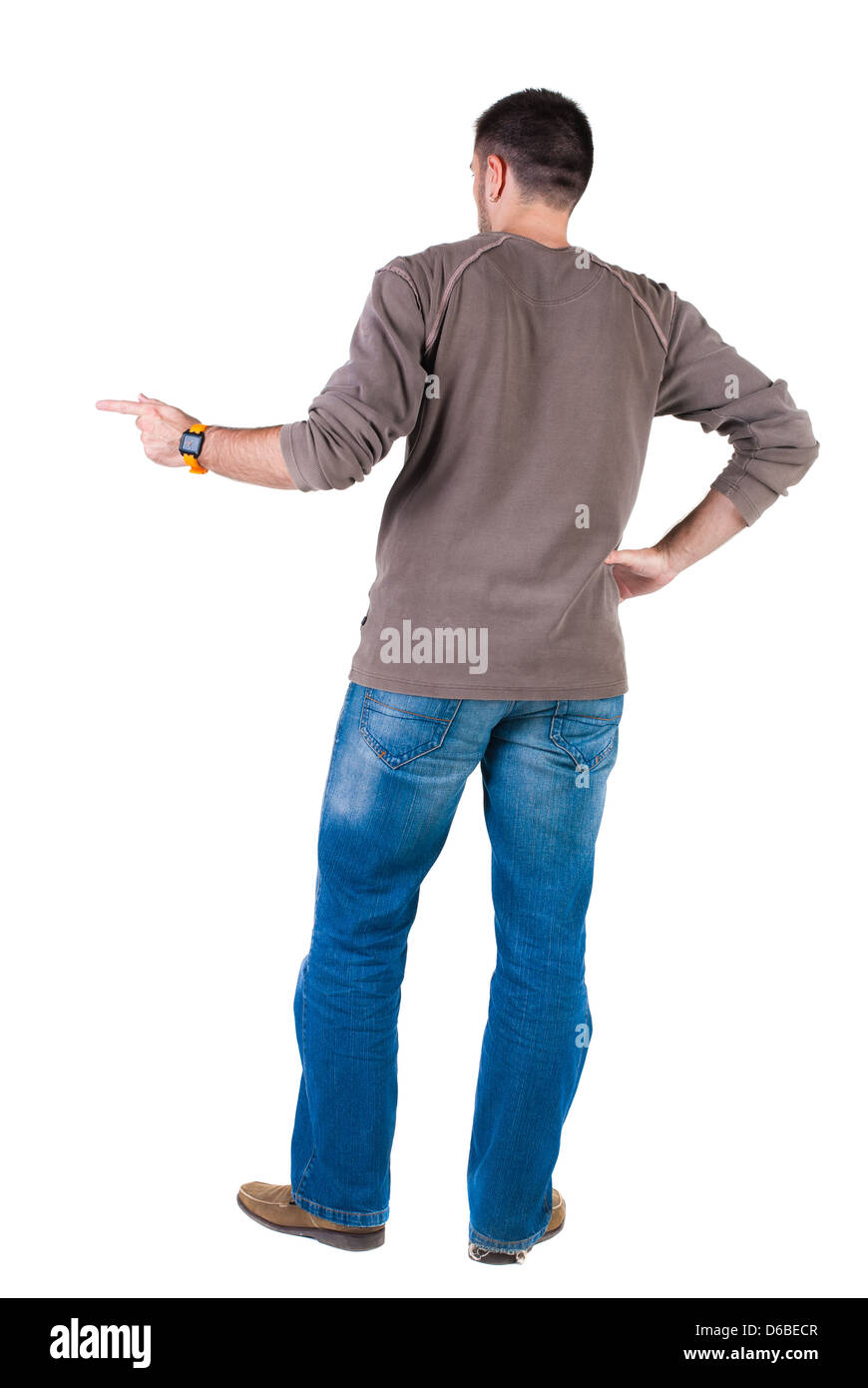 Young man pointing at wall. Rear view. Isolated over white Stock Photo ...