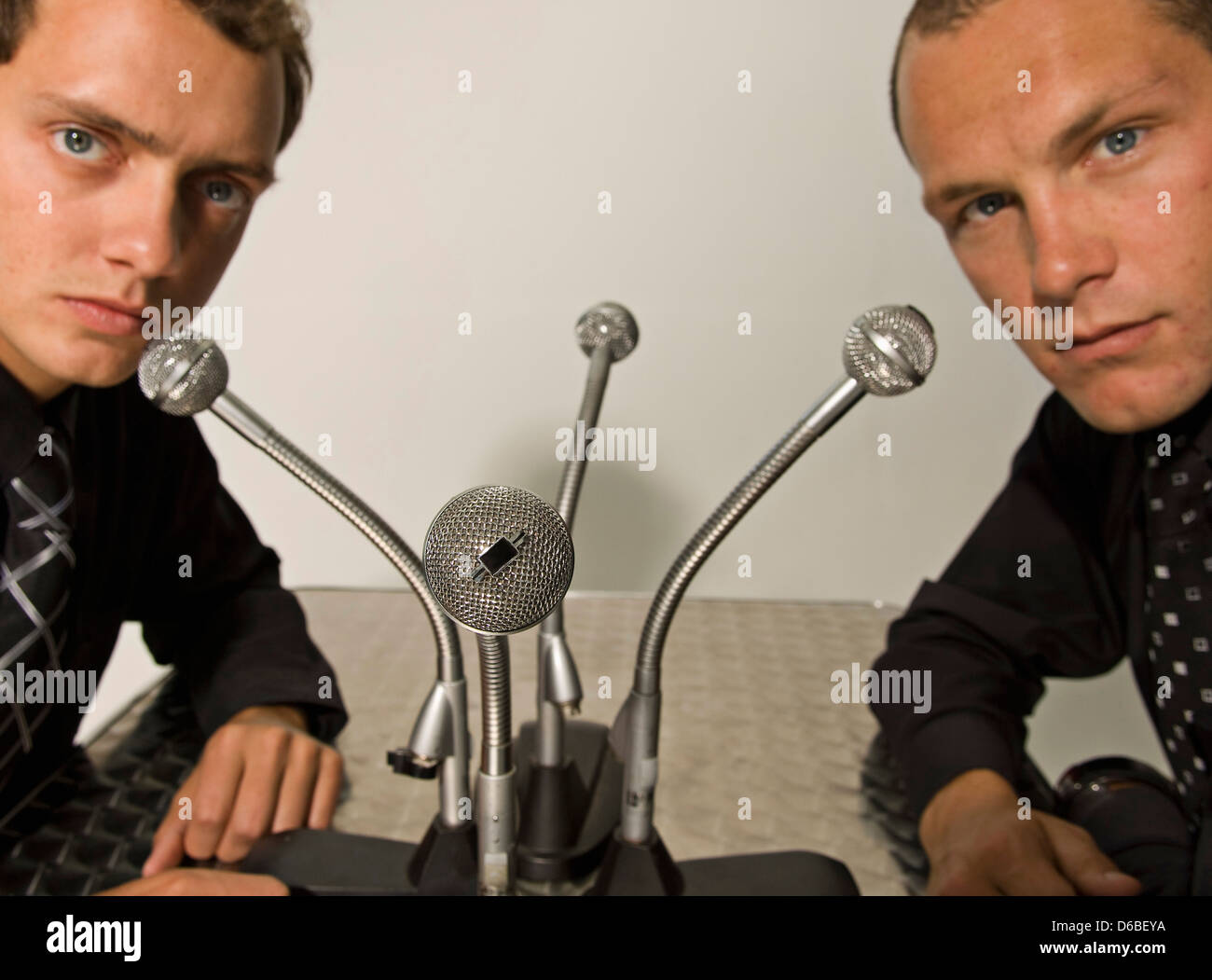 Businessmen talking into microphones Stock Photo - Alamy