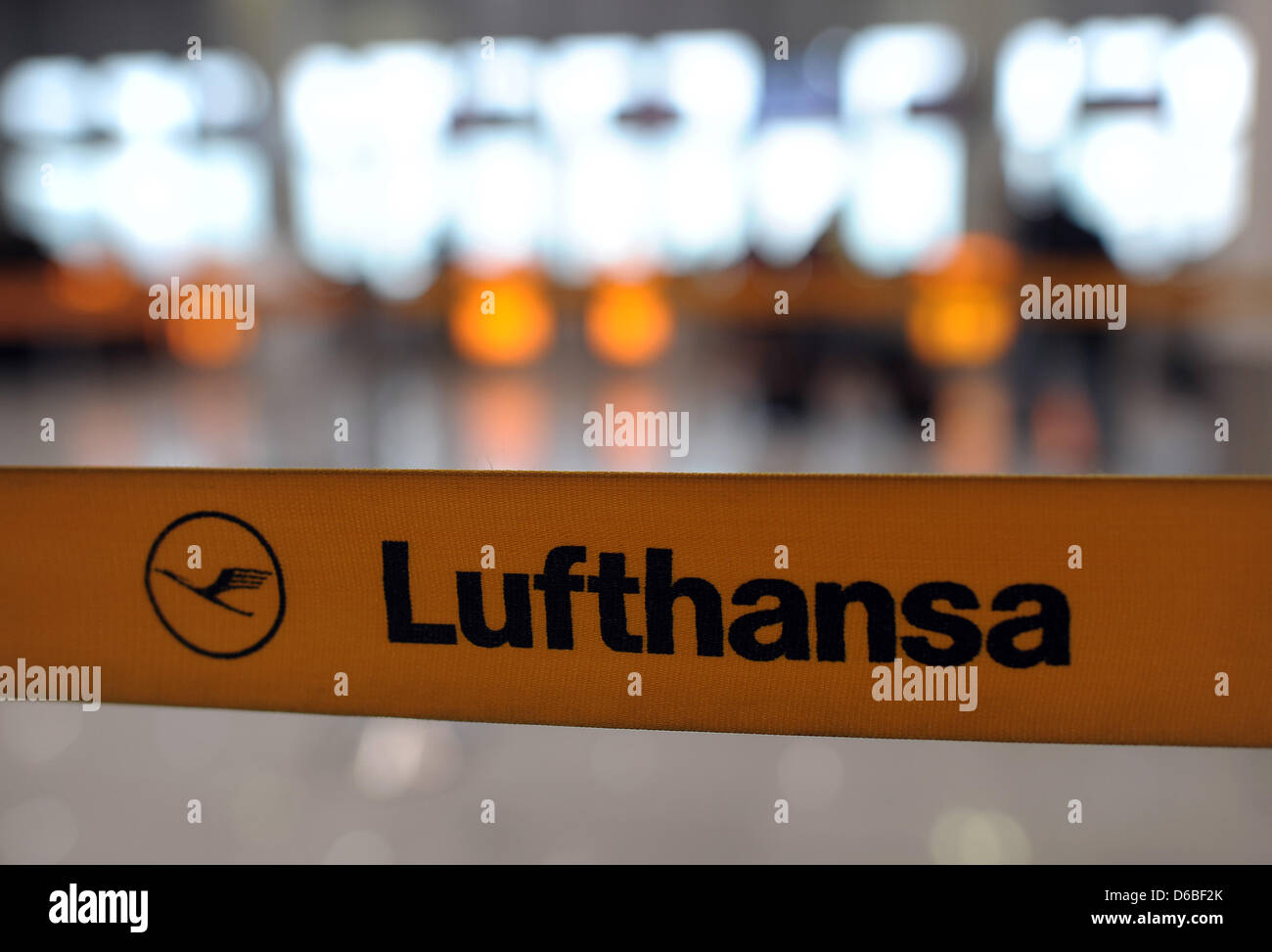 Travellers wait to check in at the Lufthansa counter at the airport in ...