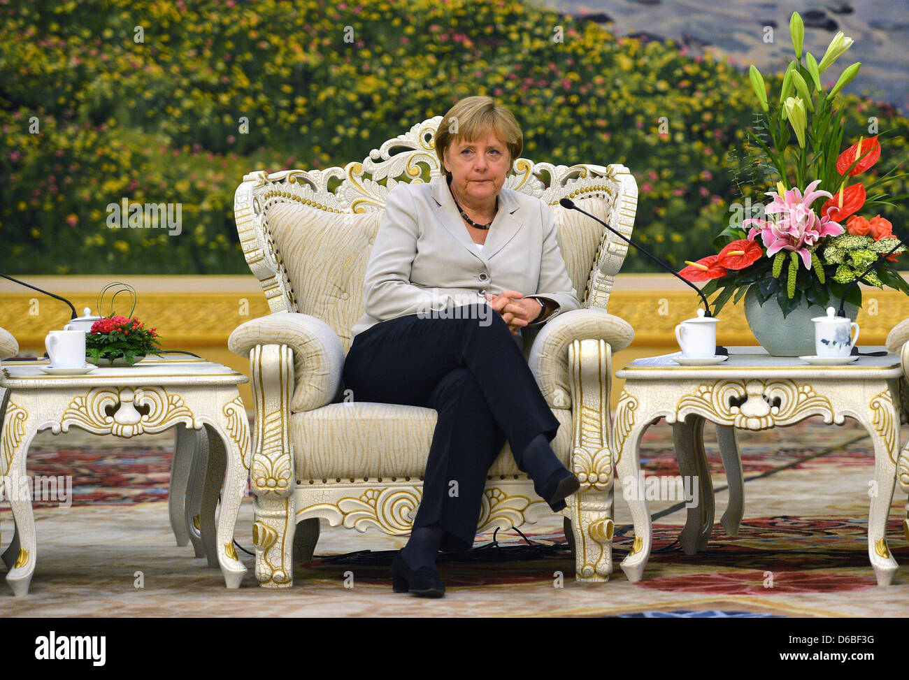 German Chancellor Angela Merkel takes a seat in the Great Hall of the ...