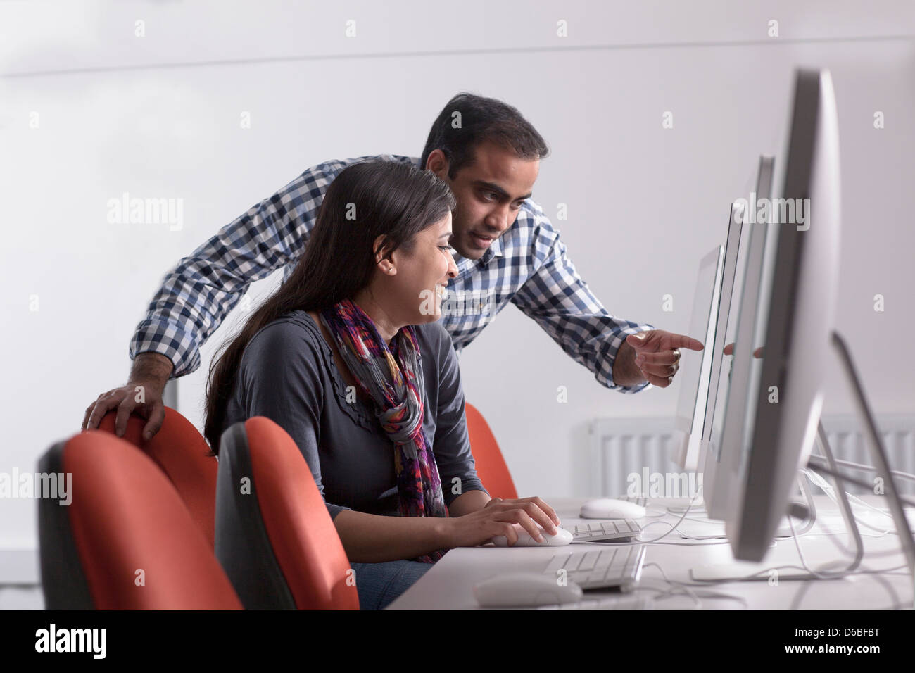 Couple pointing at computer hi-res stock photography and images - Alamy