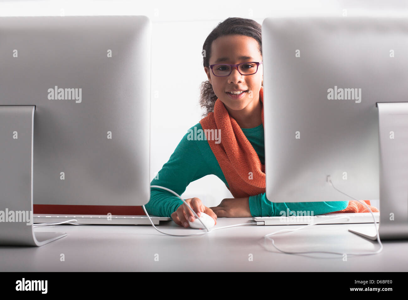 Woman using computer at desk Stock Photo - Alamy