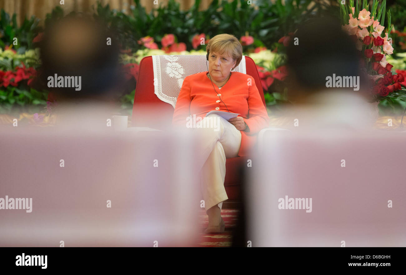 German Chancellor Angela Merkel (C) attends a meeting with Premier of ...