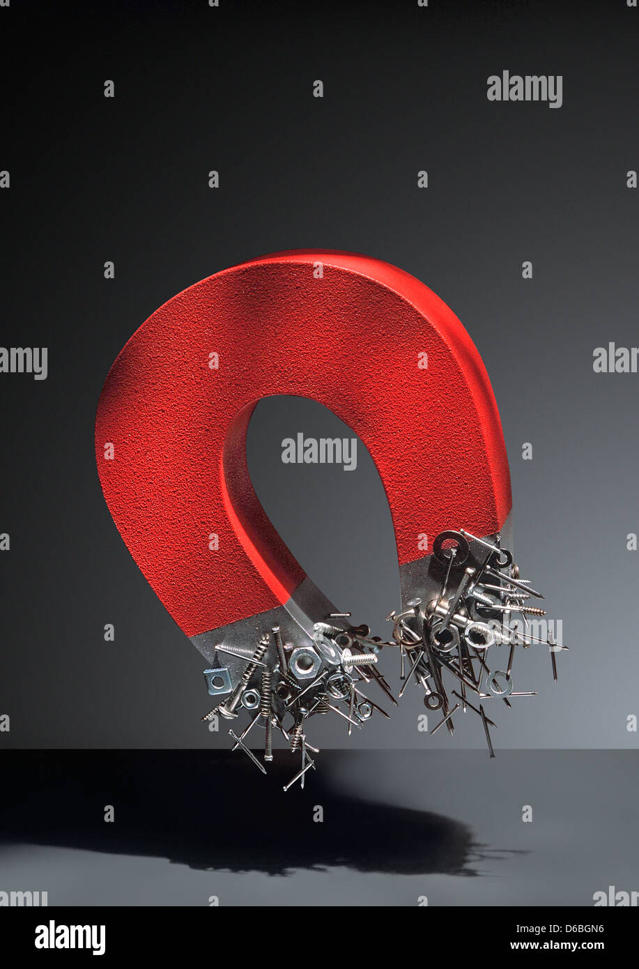 Metal objects attached to magnet Stock Photo - Alamy