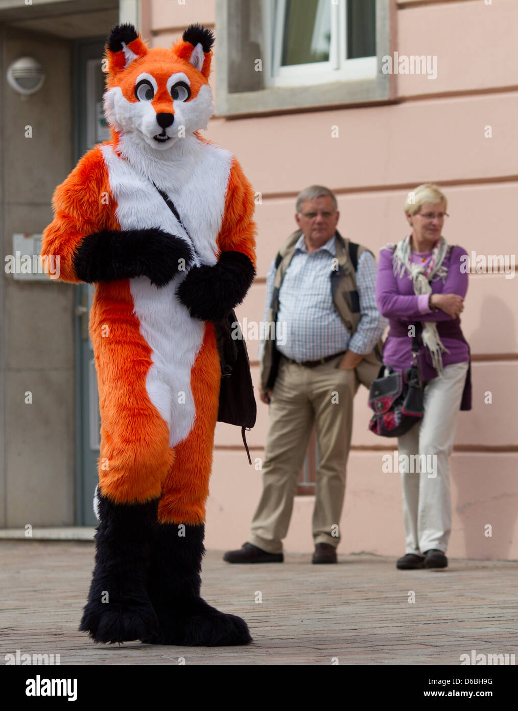 Visitors to the Eurofurence Convention talk in fanciul animal constumes ...