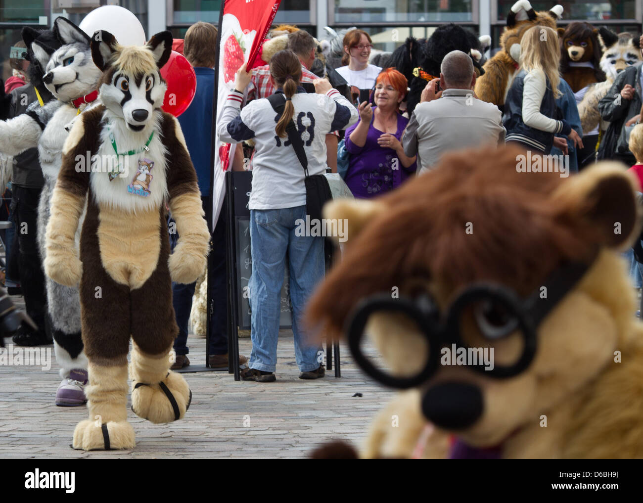 Visitors to the Eurofurence Convention talk in fanciul animal constumes ...