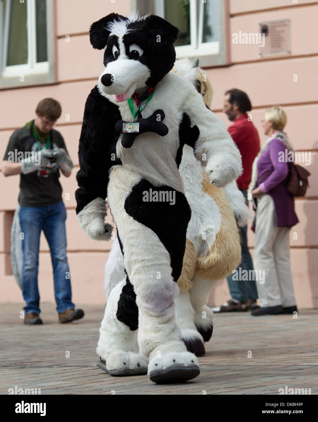 Visitors to the Eurofurence Convention talk in fanciul animal constumes ...