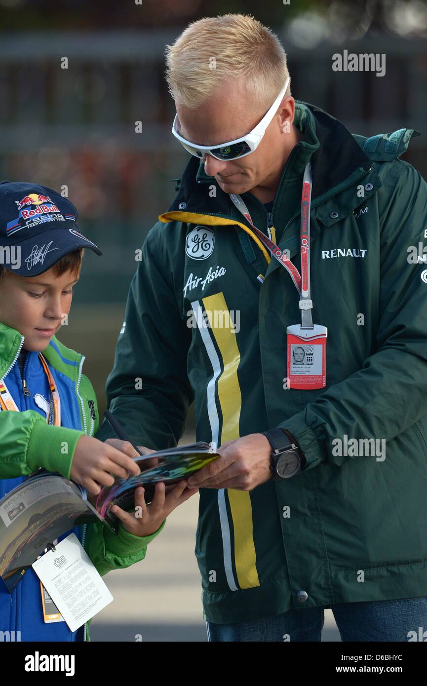 Finnish Formula One driver Heikki Kovalainen of Caterham sign an ...