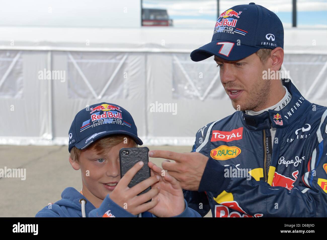German Formula One driver Sebastian Vettel (r) of Red Bull takes the ...