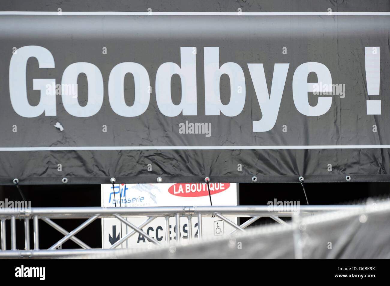 A sign reading "Goodbye" at the exit of the paddock at the race track ...