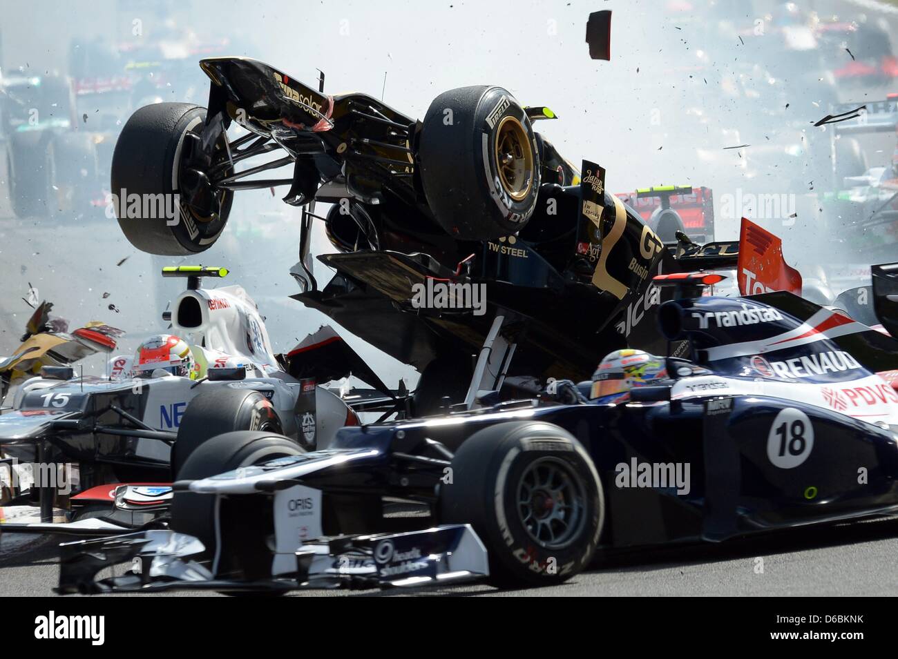 French Formula One driver Romain Grosjean (C) of Lotus and hits the ...