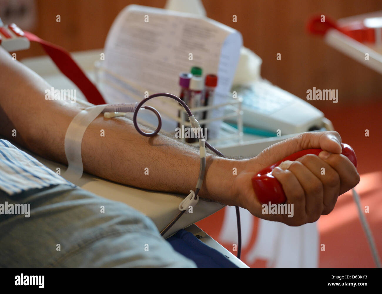 A young man donates blood at Bait ul Rasheed mosque during a blood ...