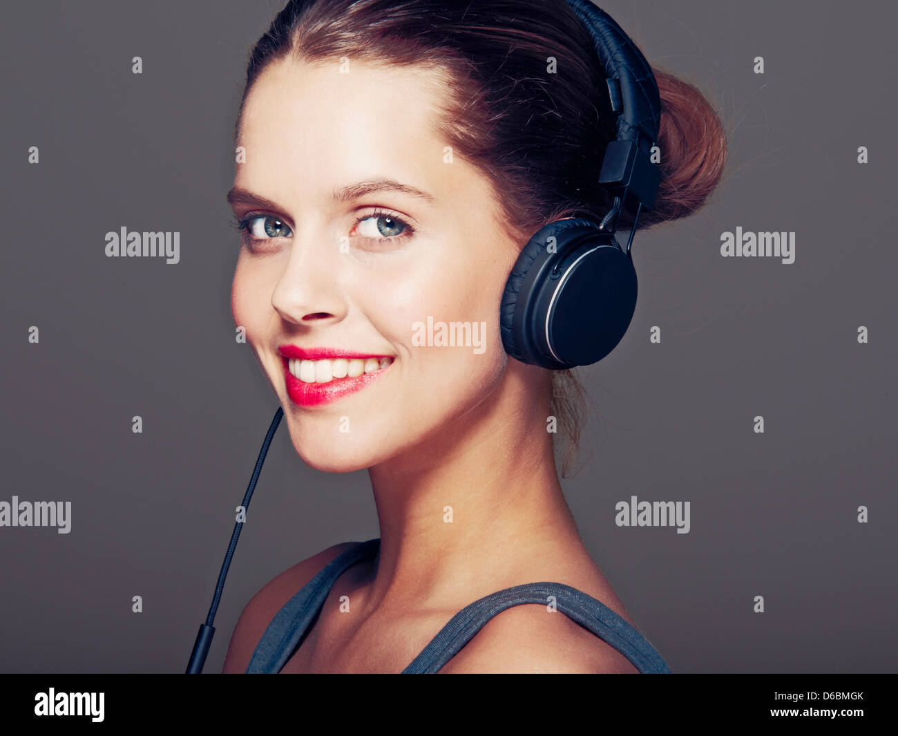 Smiling woman wearing headphones Stock Photo - Alamy